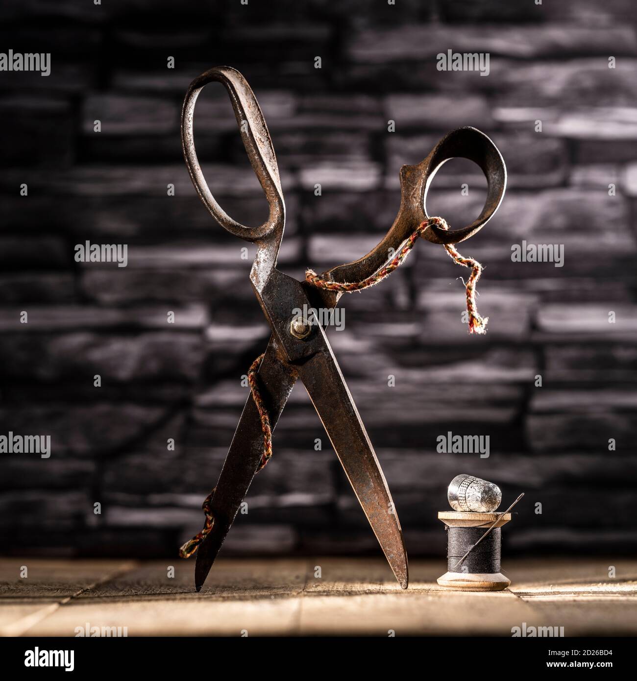 Rusty vintage pair of scissors balanced on timber flooring with black ...