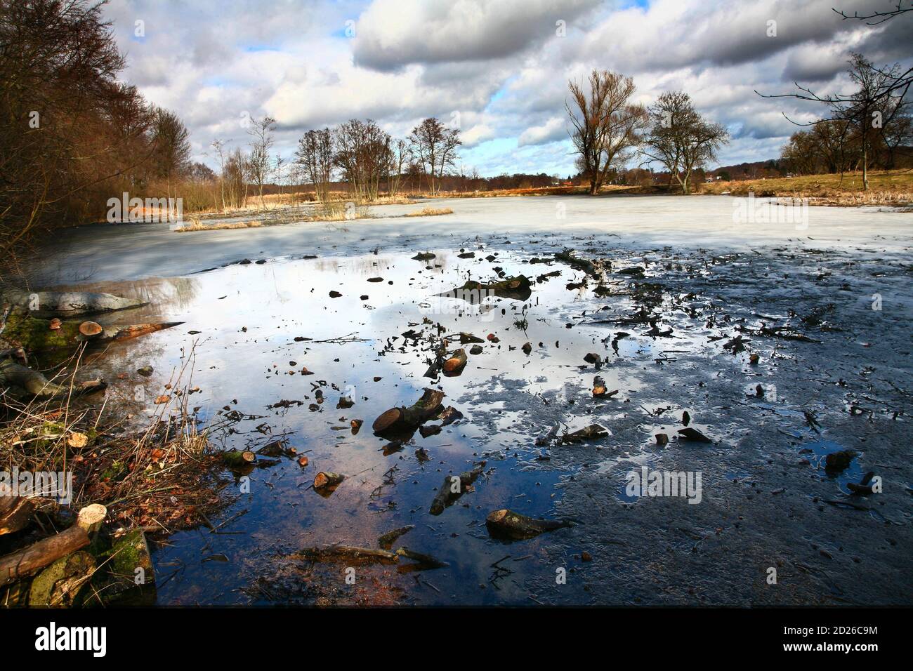 Iced lake in sun in denmark in winter Stock Photo - Alamy