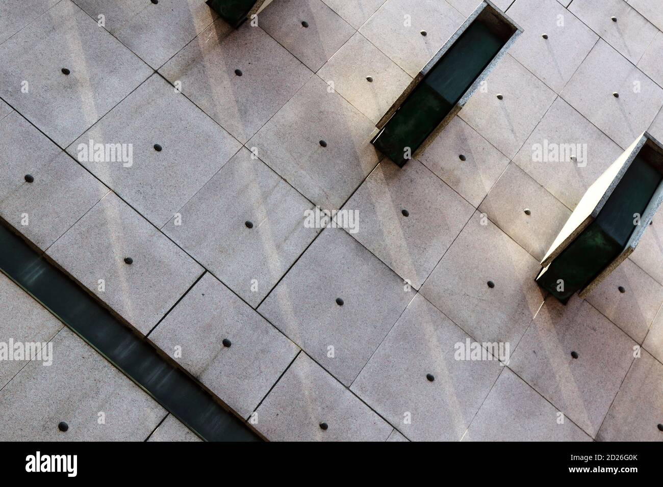 abstract and geometric framing of a wall covered with concrete tiles ...