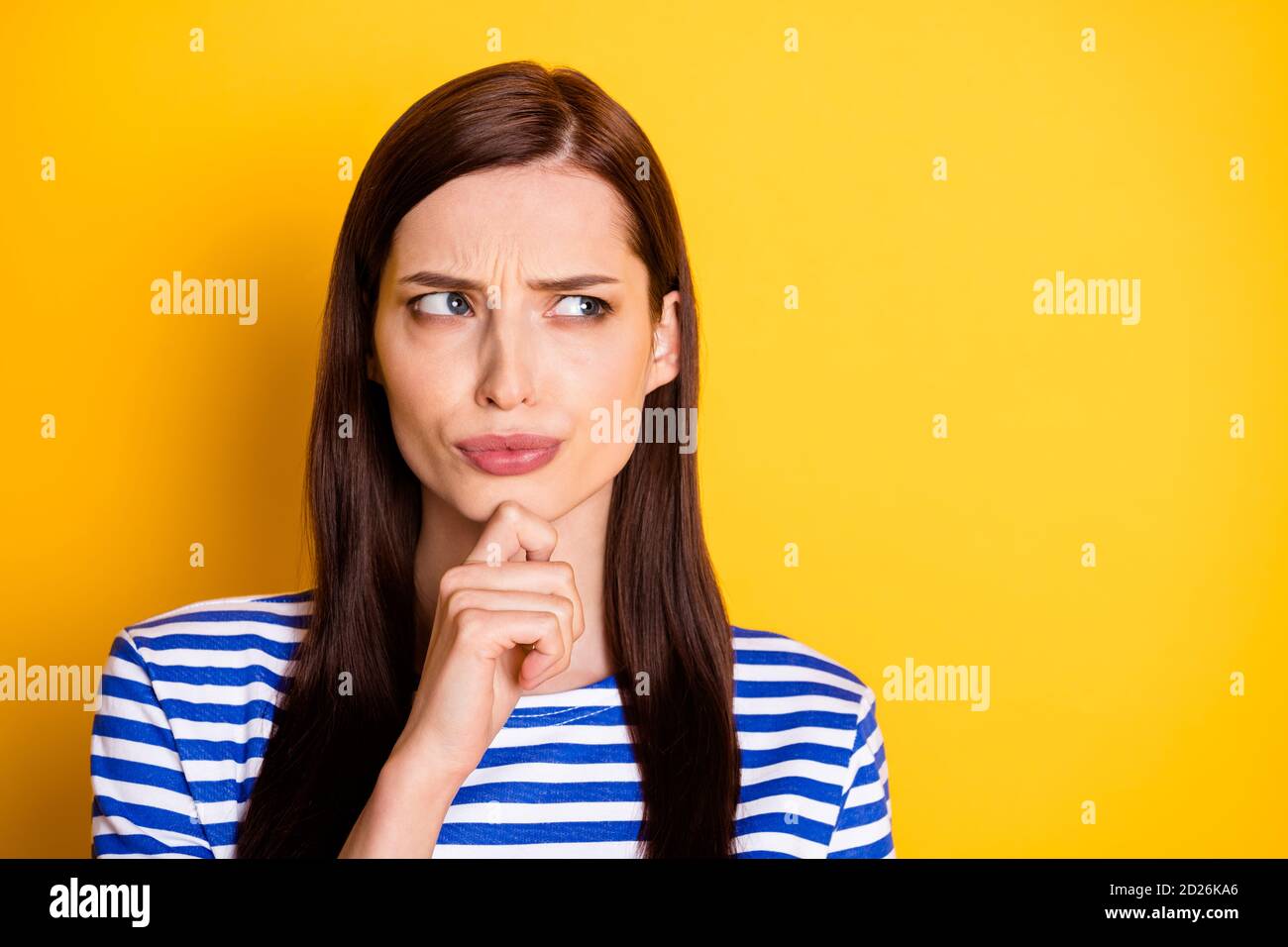 Portrait of unsure girl touch finger chin look copyspace think thoughts ...