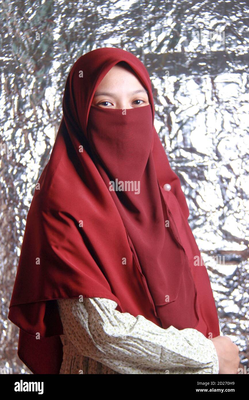 portrait of veiled Asian woman on silver paper background. beautiful ...