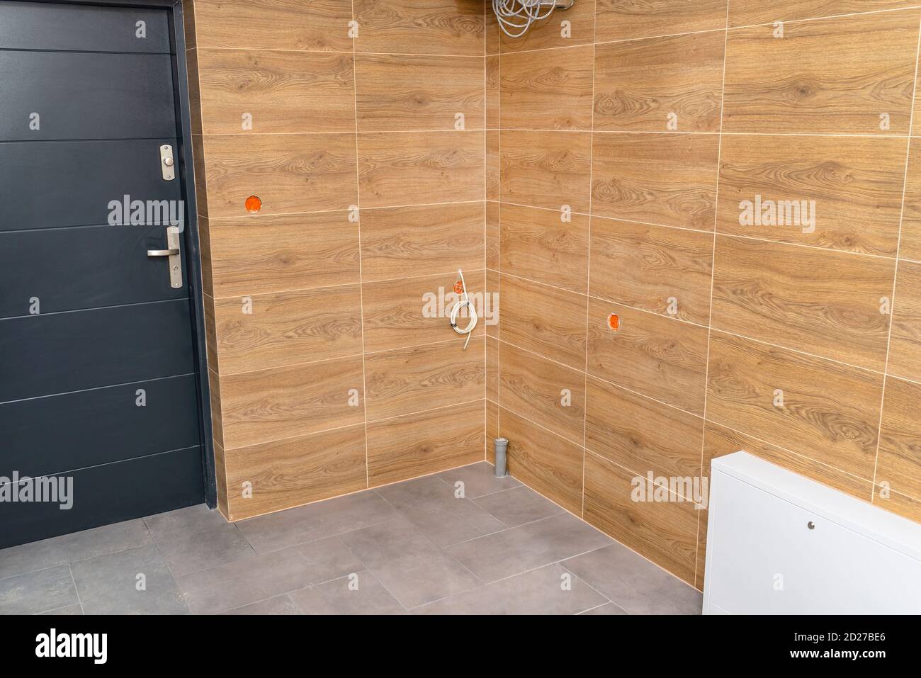 Modern gas boiler room with brown ceramic tiles imitating wood, empty ...