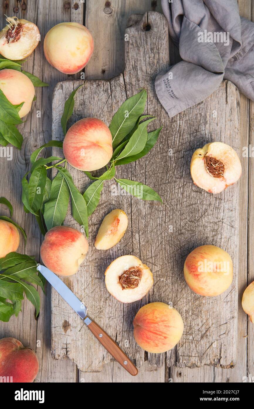 Several ripe juicy peaches on a wooden surface. Peach fruits on the ...