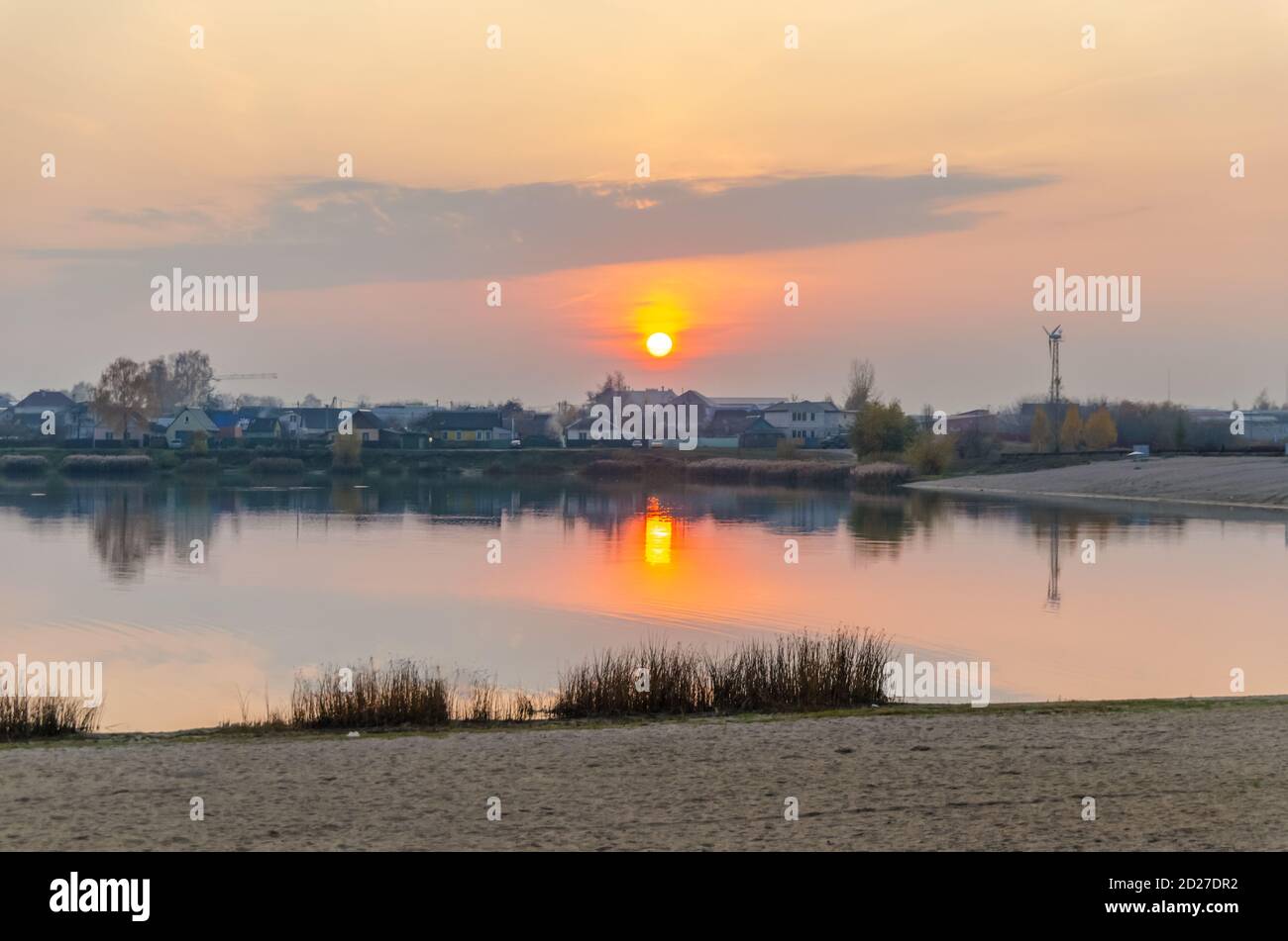 Gentle Sunset over the lake with part of the beach Stock Photo - Alamy