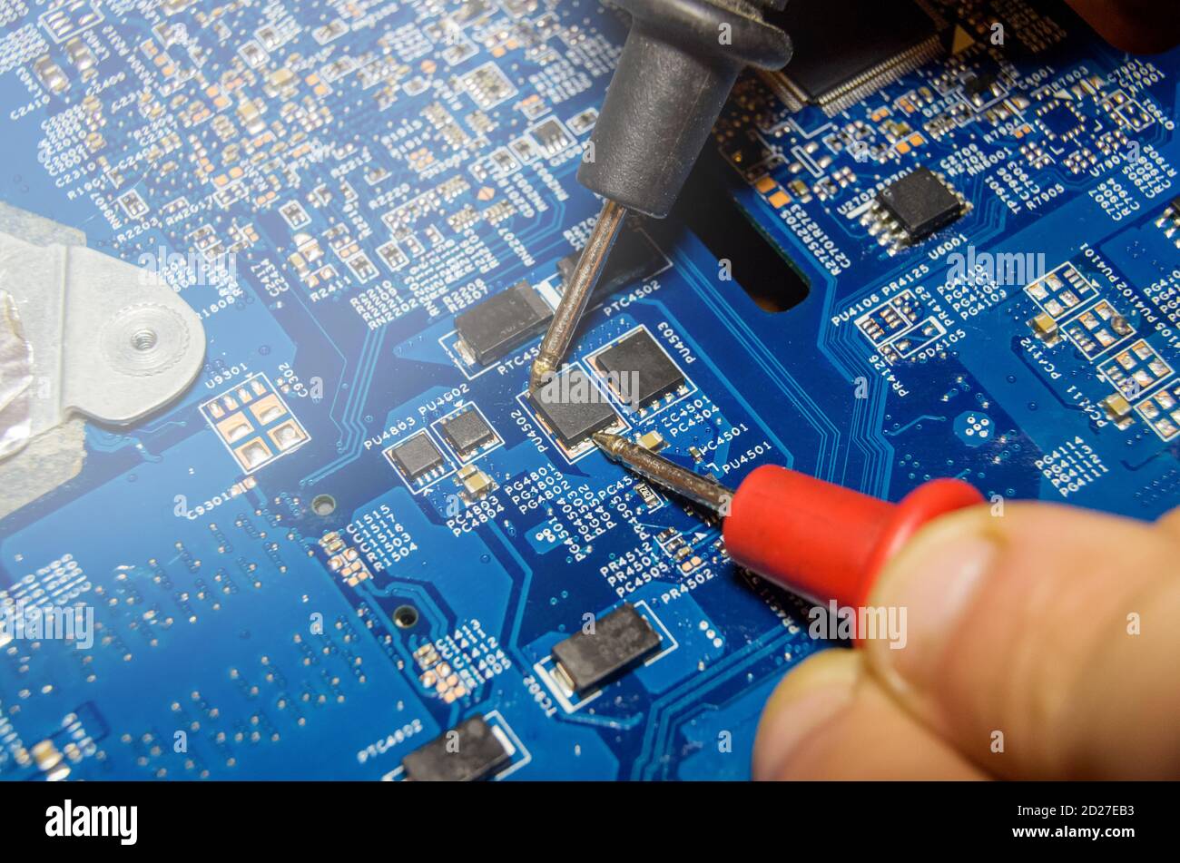 colorful electronic board and tools repairs on old laptop, vibrant ...