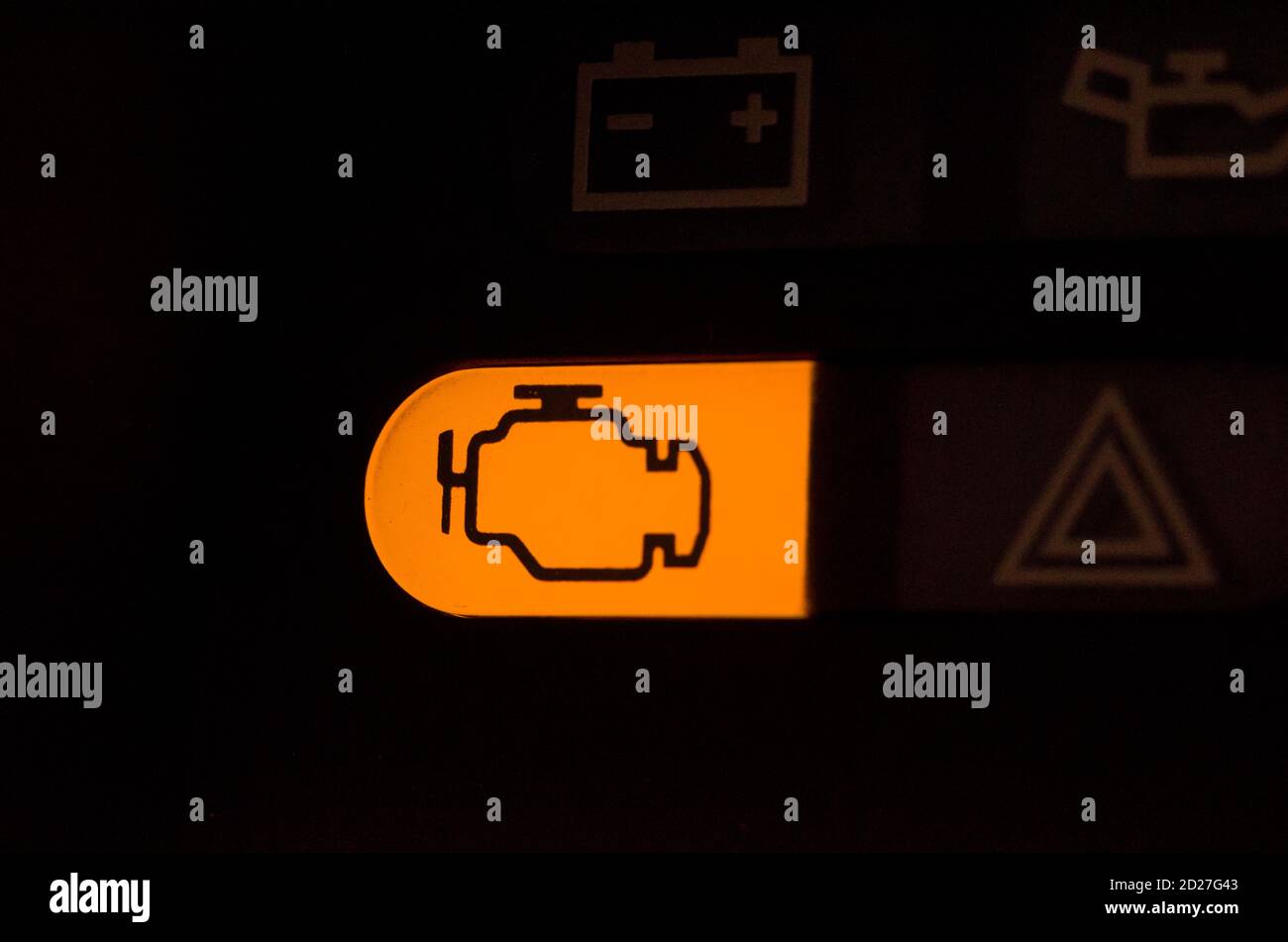 Warning sign of a car engine, orange engine sign on a panel of car ...