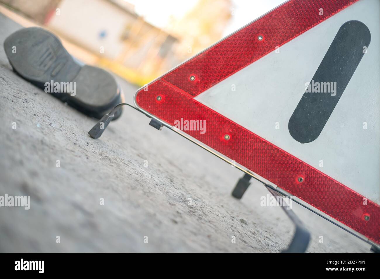 An accident on the road involving a person. Close up of a man's boot ...