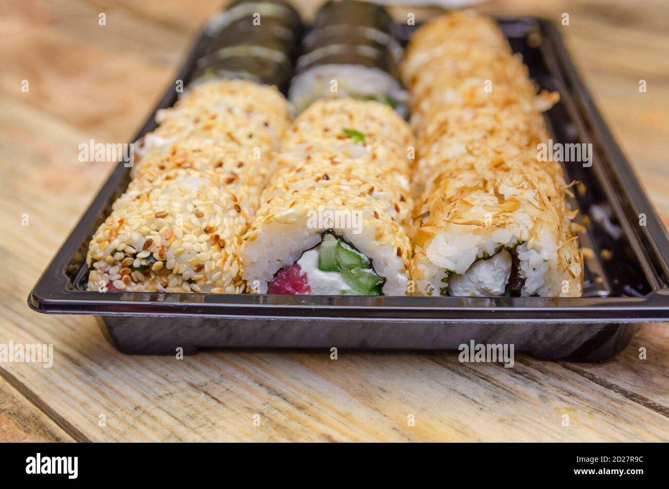 Set sushi Toto Maki, Bonito Maki, Akito Maki on a wooden background ...