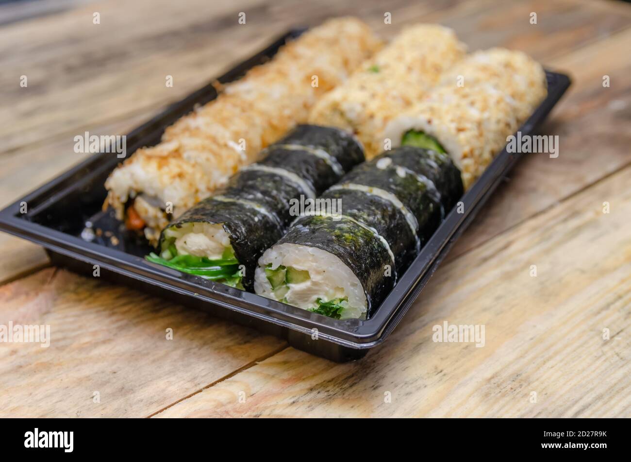 Set sushi Toto Maki, Bonito Maki, Akito Maki on a wooden background ...