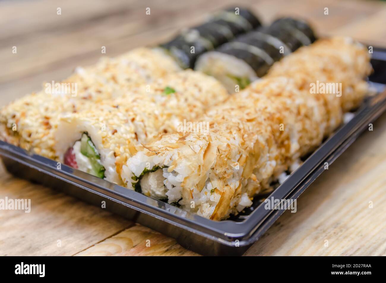 Set sushi Toto Maki, Bonito Maki, Akito Maki on a wooden background ...