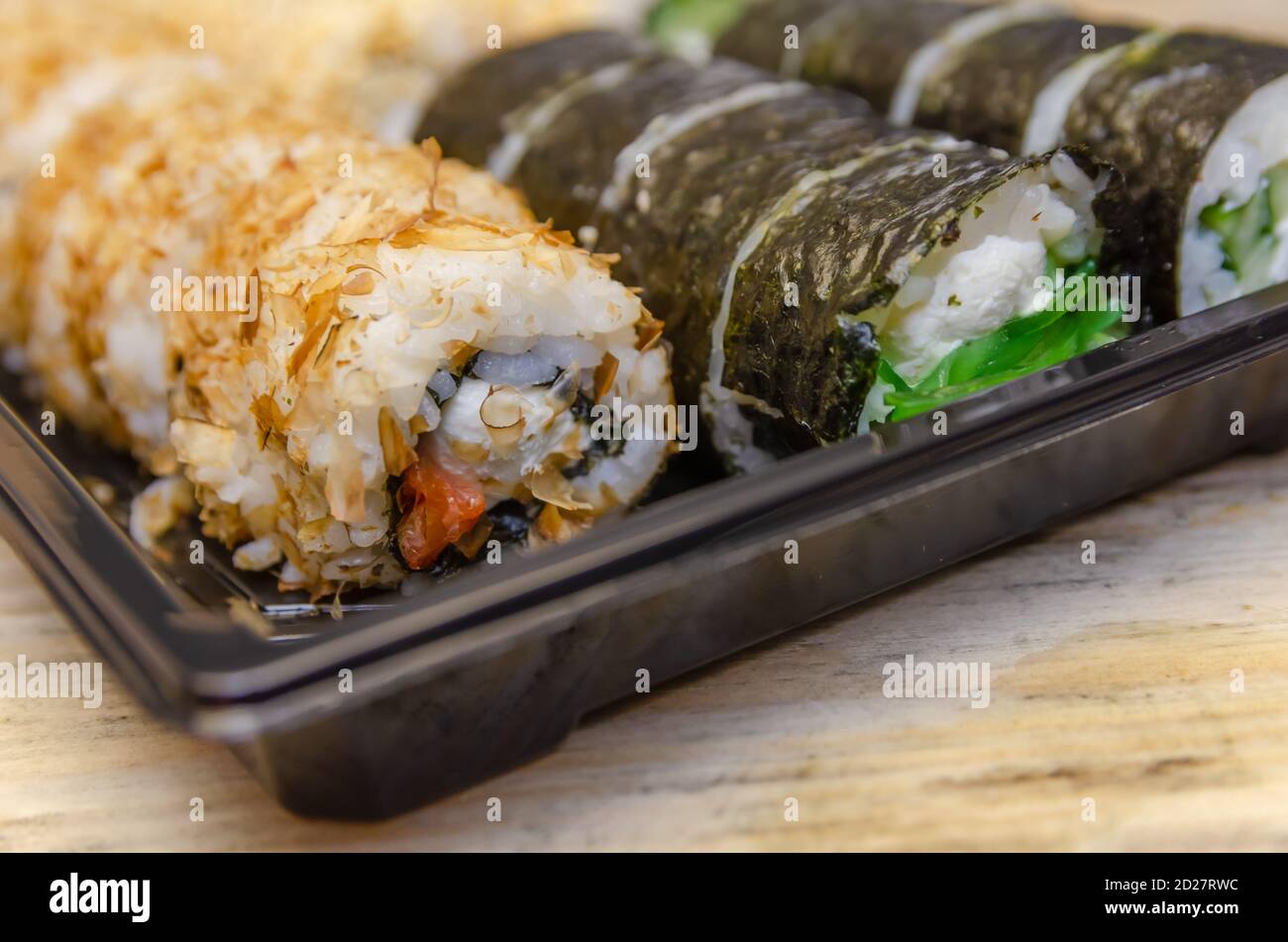 Set sushi Toto Maki, Bonito Maki, Akito Maki on a wooden background ...