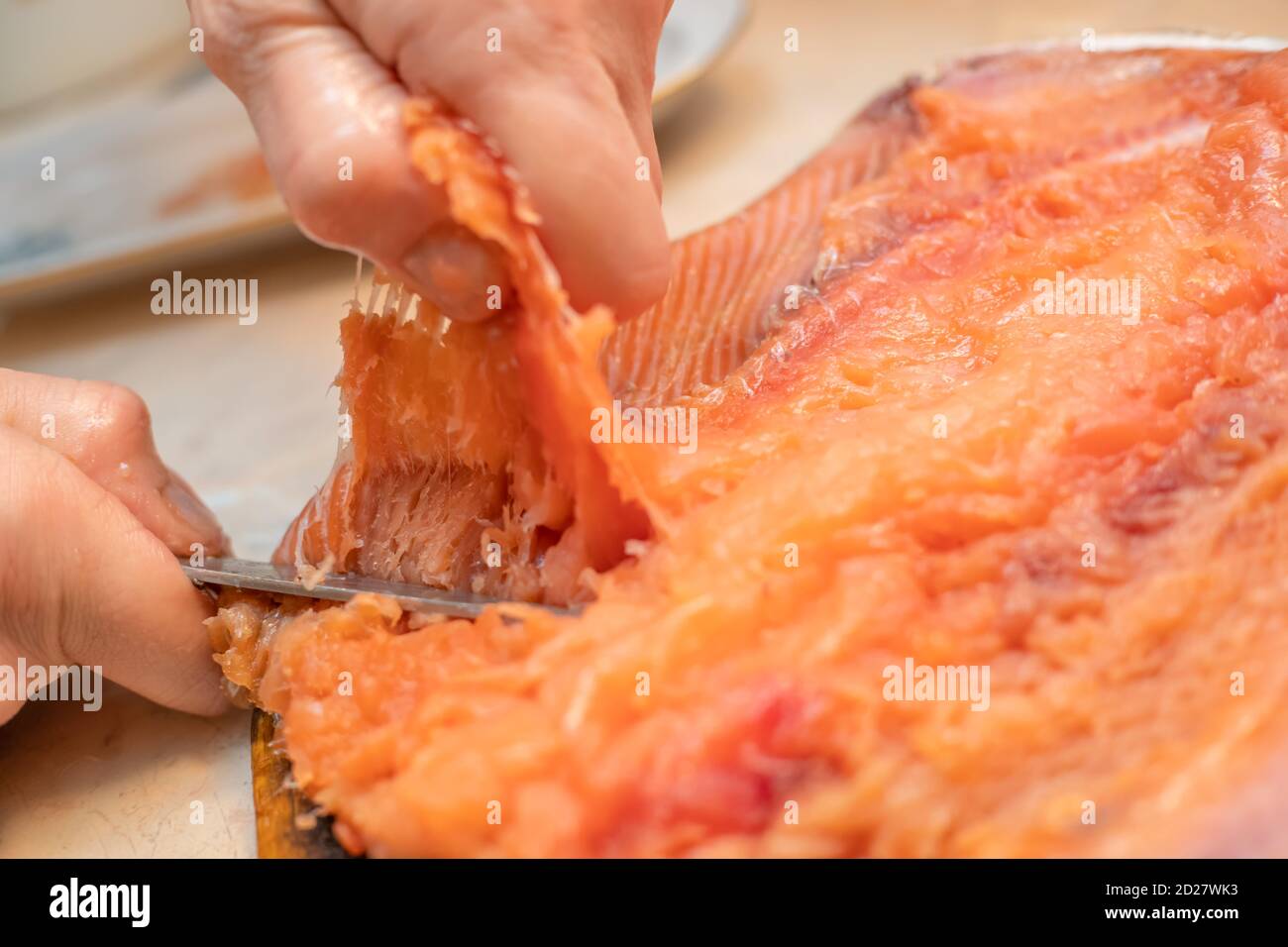 Cleaning fillet of salted pink salmon close-up Stock Photo - Alamy