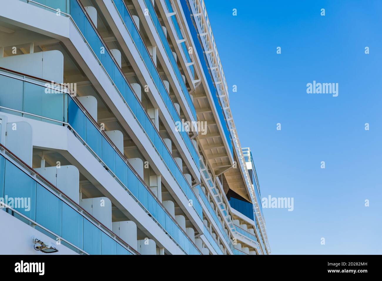 Low angle shot of glass windows and balconies on a large cruise ship ...