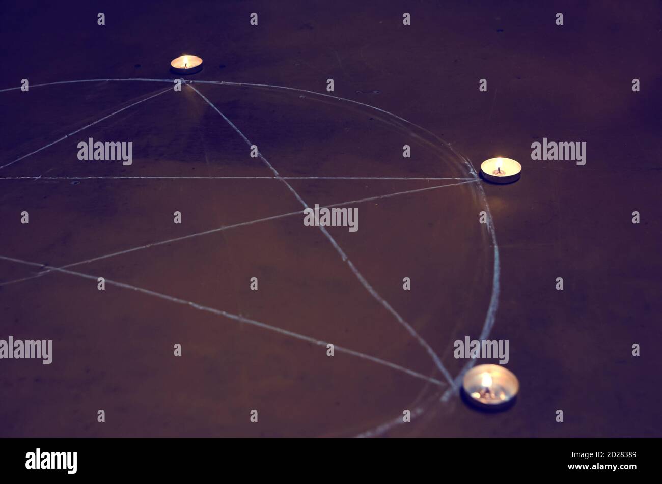 Candles on a pentagram on the wooden floor. magical ritual with occult ...