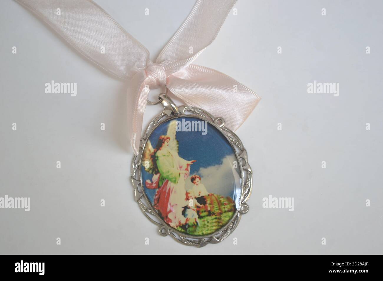 Medal, guardian angel and children figure, in iron medal, with pink bow ...