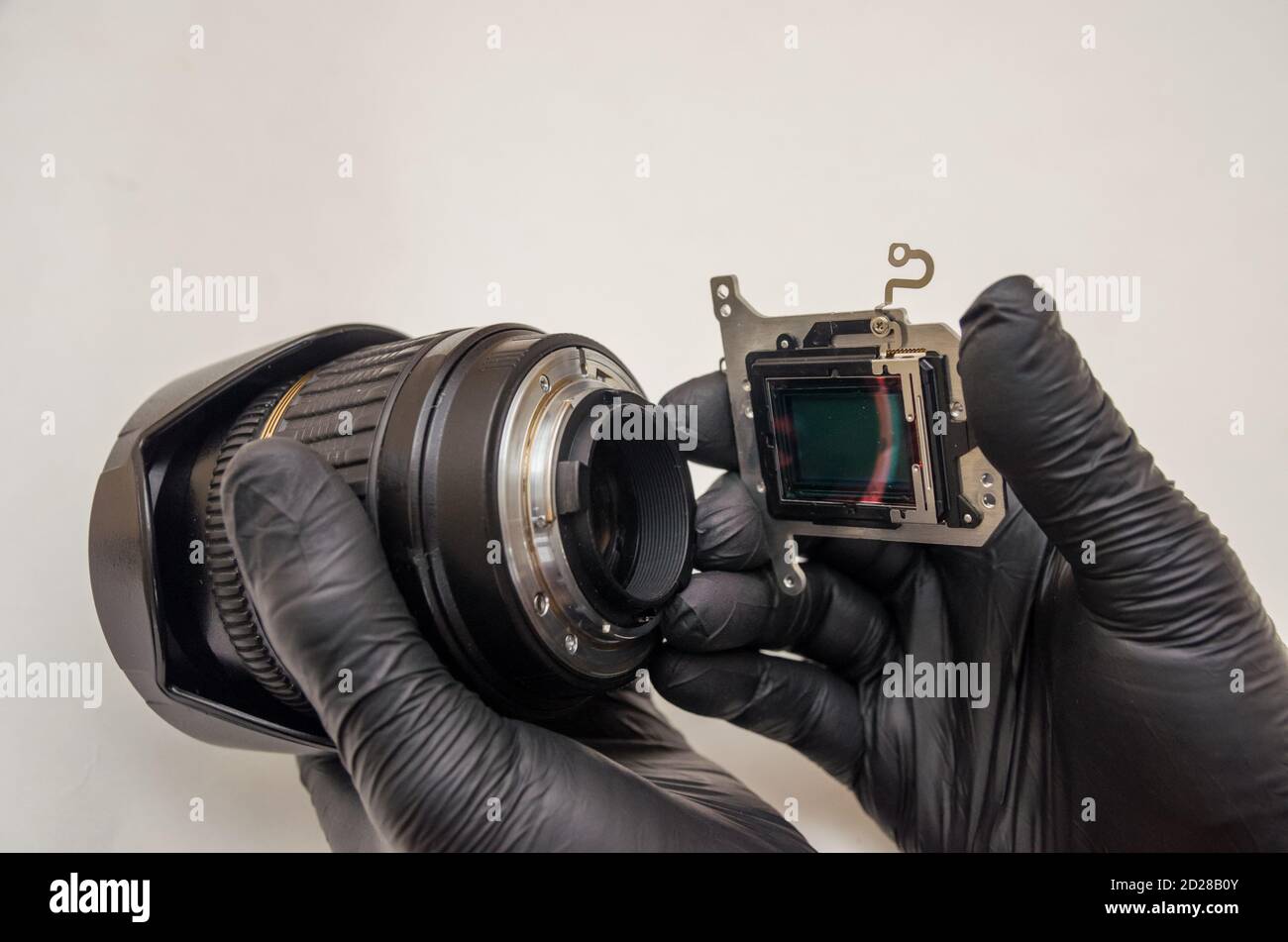 The lens and the matrix in the hands of the master in repair Stock ...