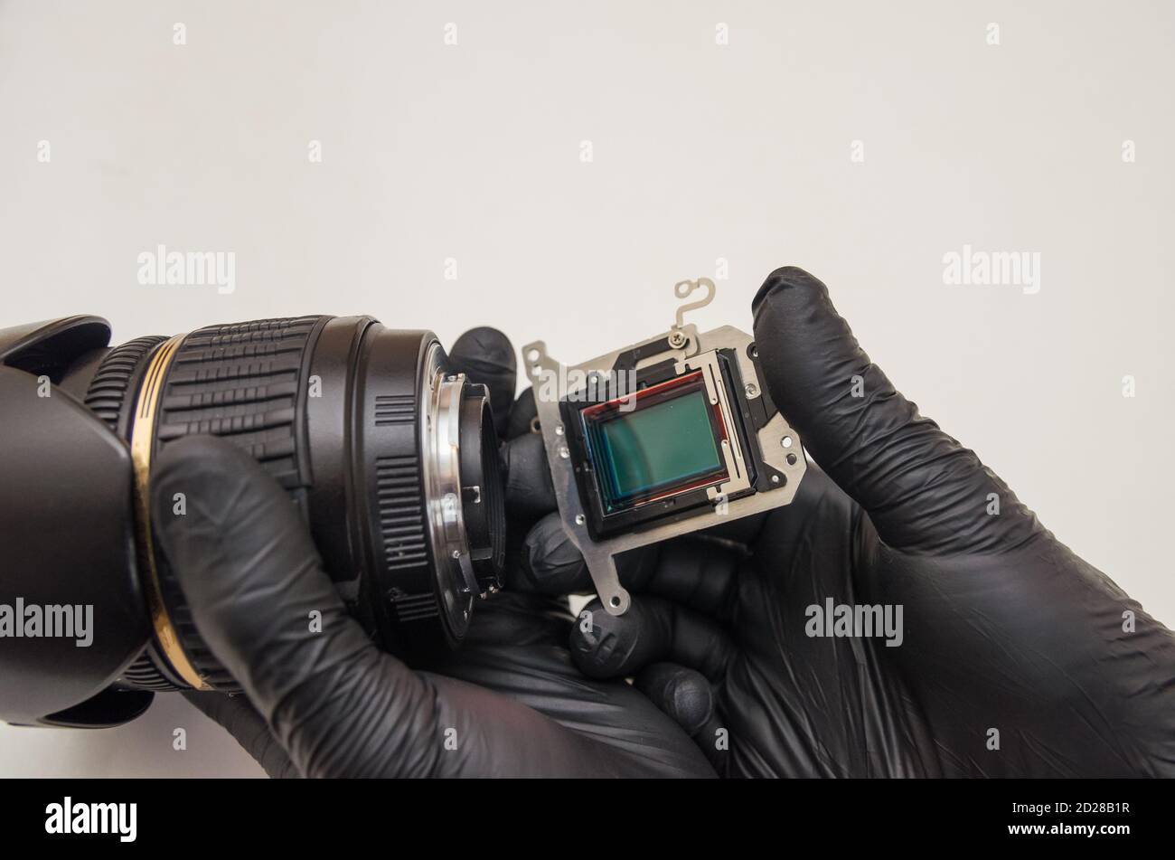 The lens and the matrix in the hands of the master in repair Stock ...