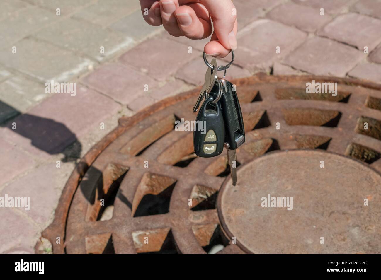Girl's hand with the keys to the car over the grill hatch. Drop car ...