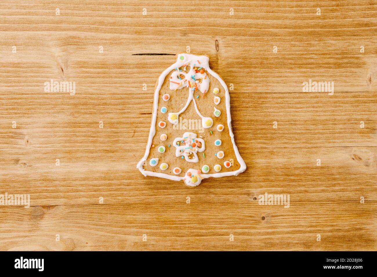 Bell-shaped gingerbread, decorated with icing and sprinkling, on a ...
