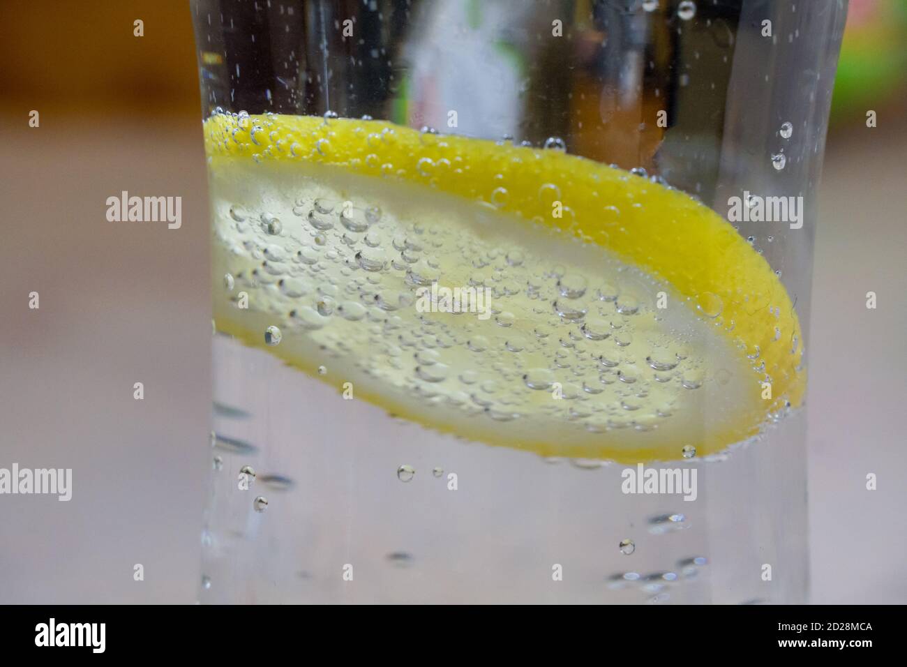 a glass of fresh drinking water and lemon. bubbles in a glass mineral ...