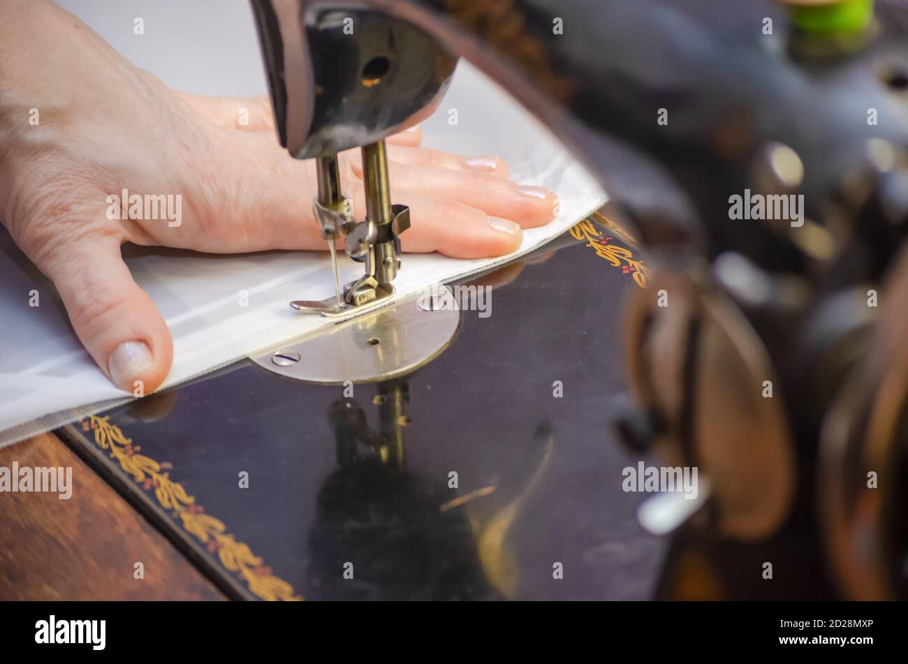 Hands of a woman who sews on an old sewing machine close up Stock Photo ...