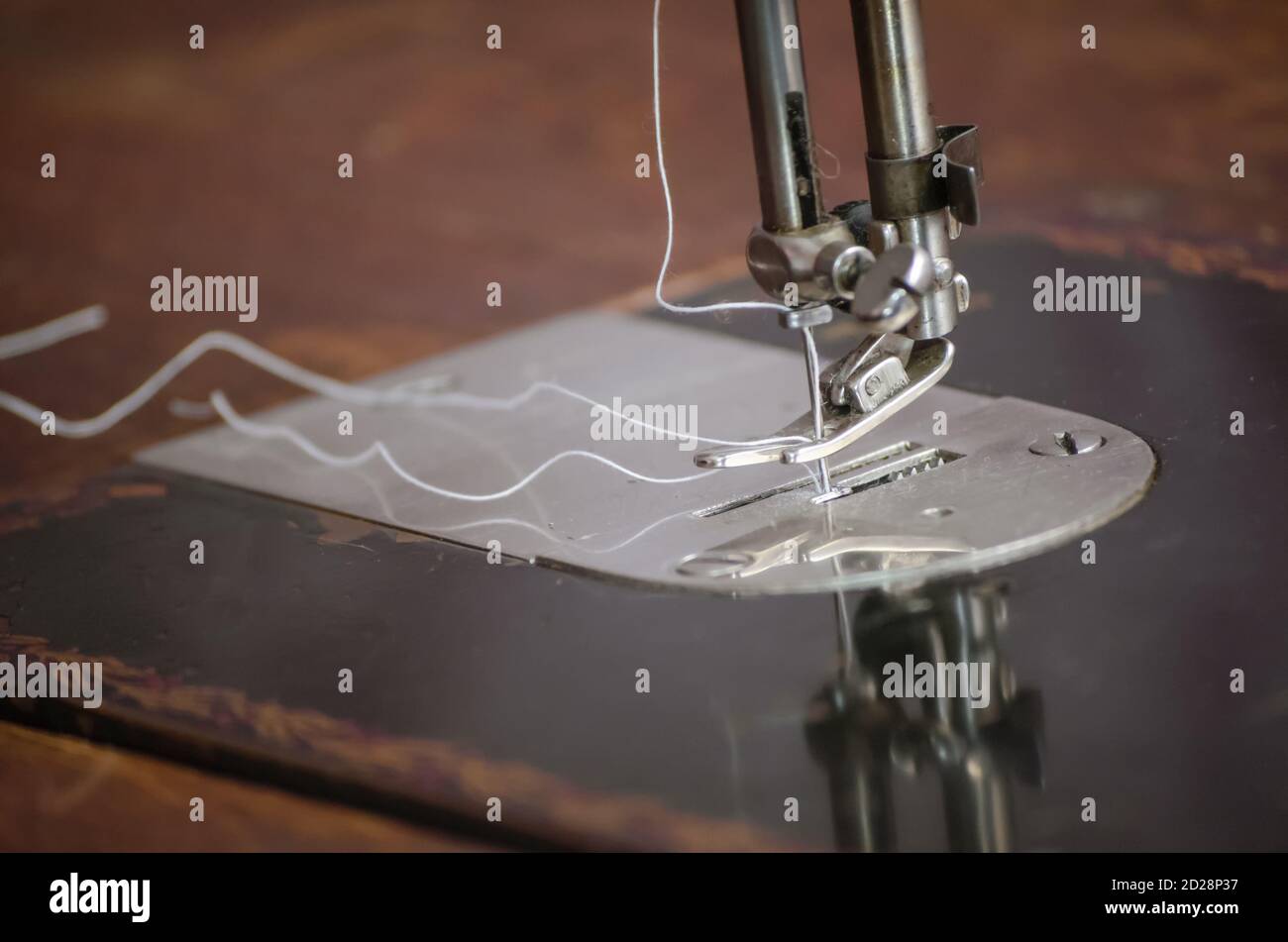 Close up sewing needle with white thread Stock Photo - Alamy