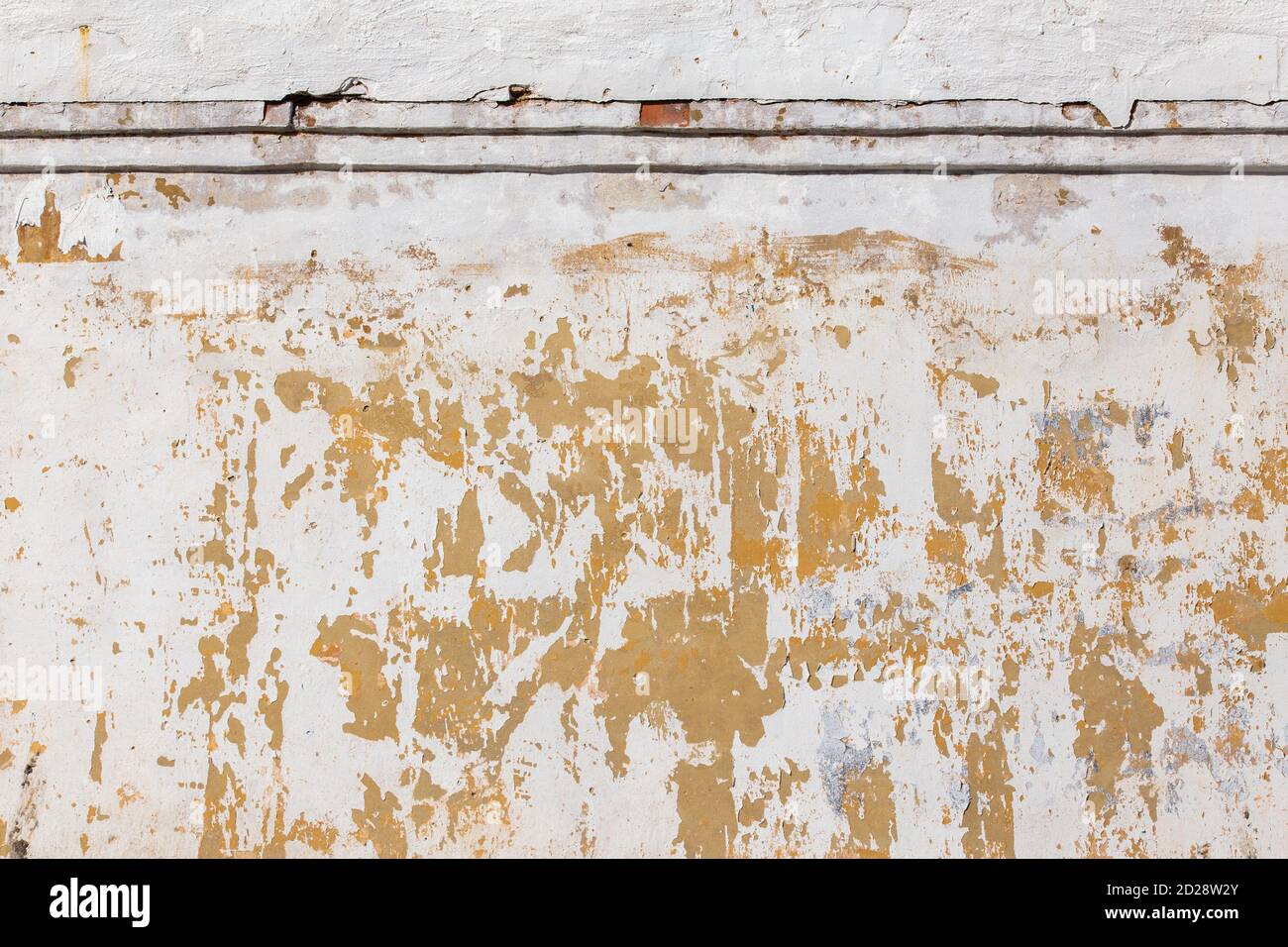 Shabby flat plaster and painted wall with big yellow under layer spots ...