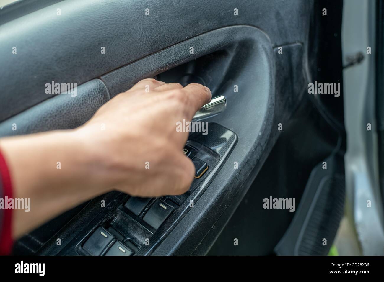 Male hand opening the car door from the inside close up Stock Photo - Alamy