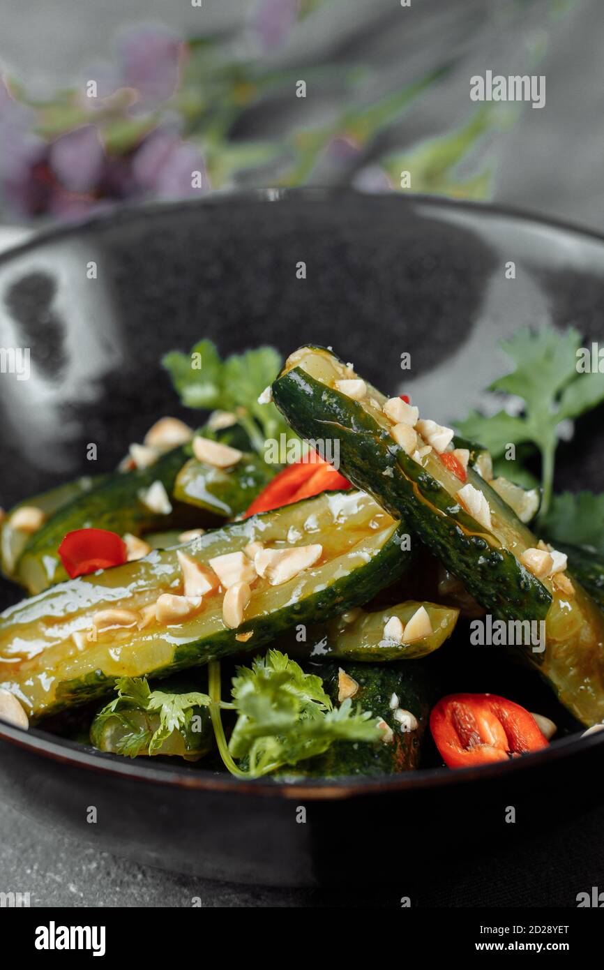 Salad of broken cucumbers with sesame seeds, sugar, red and black ...