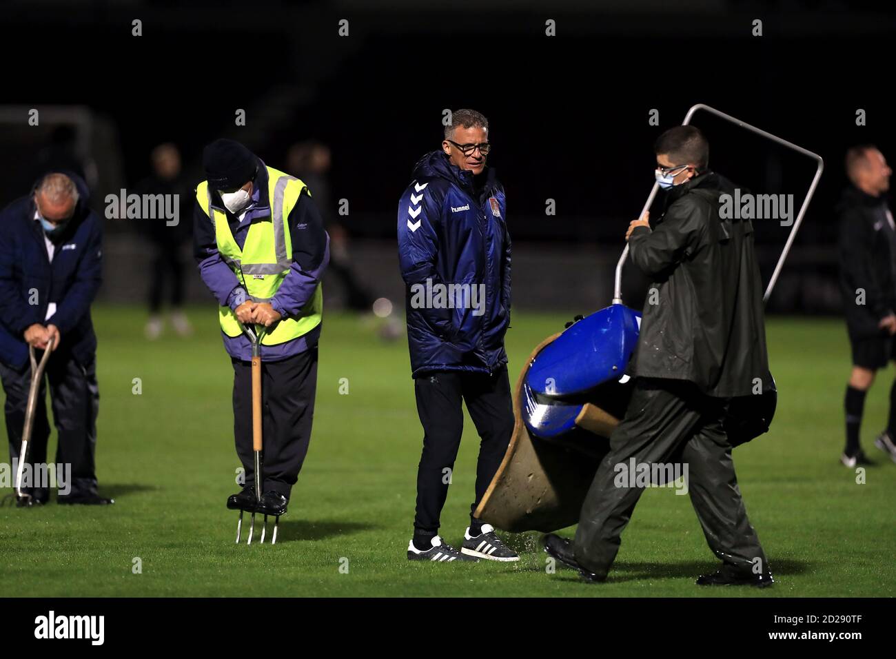 Northampton town manager Keith Curle helps the ground staff with a ...