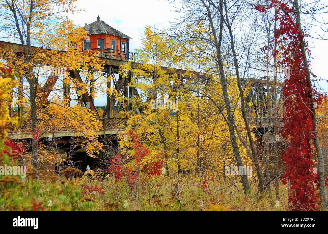 Red and Gold foliage grow in front of a 1908 Grand Trunk Railroad swing ...