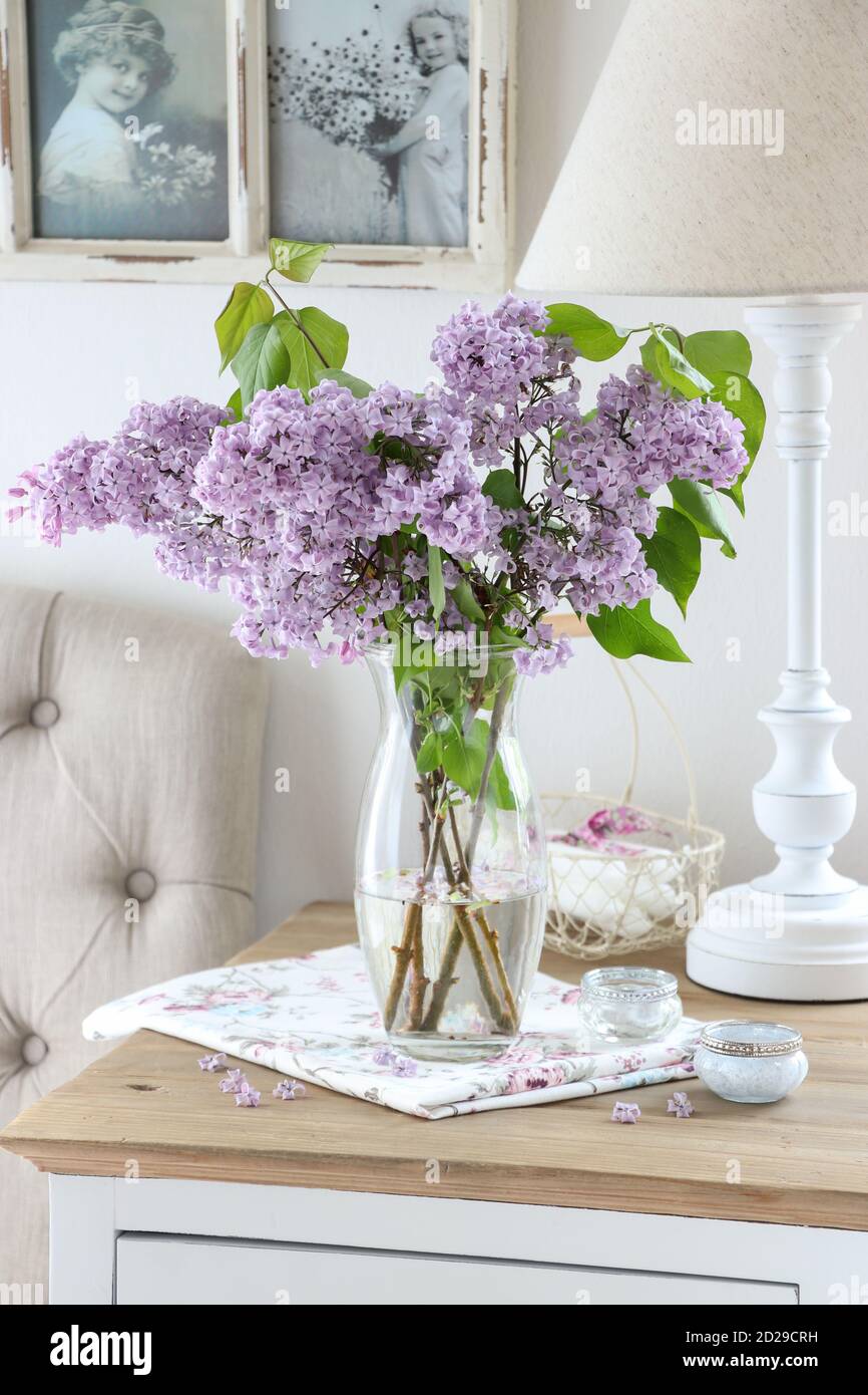 spring decoration with bouquet of lilac in glass vase Stock Photo - Alamy