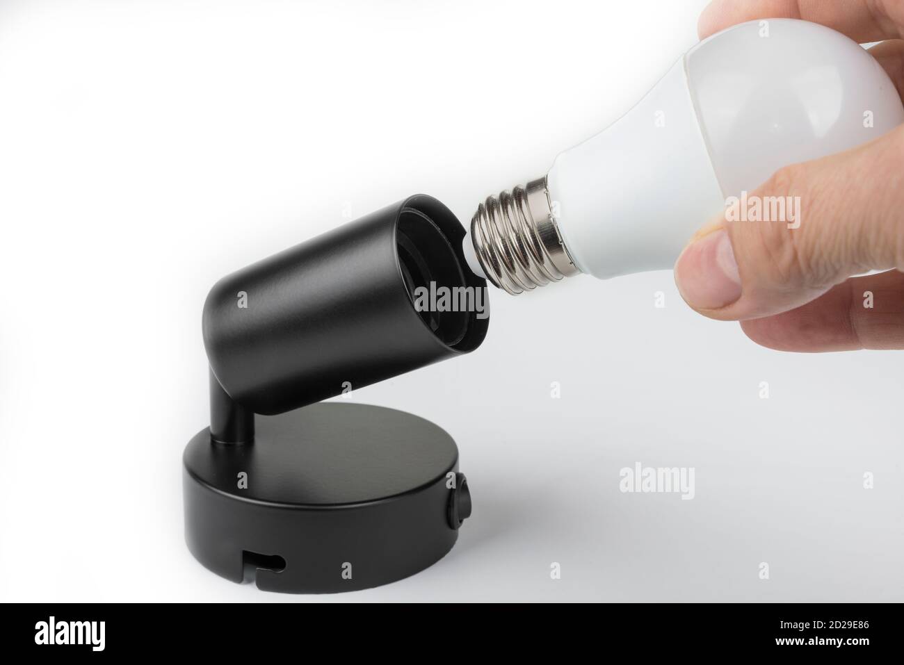 Screw in led bulb into the lamp Stock Photo - Alamy