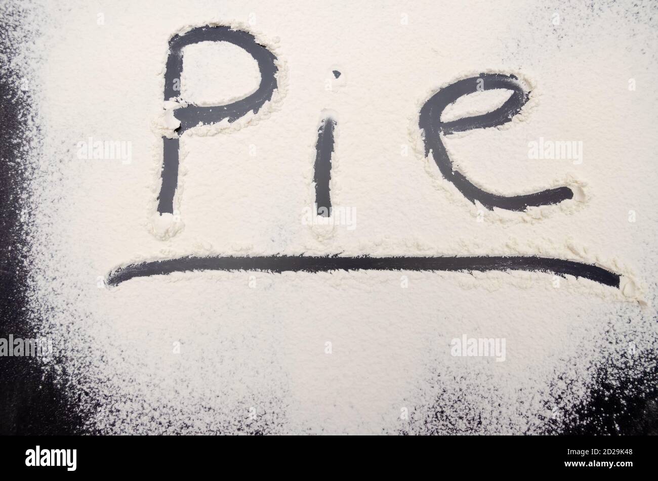 word Pie is written on a black background with the flour. Inscription ...