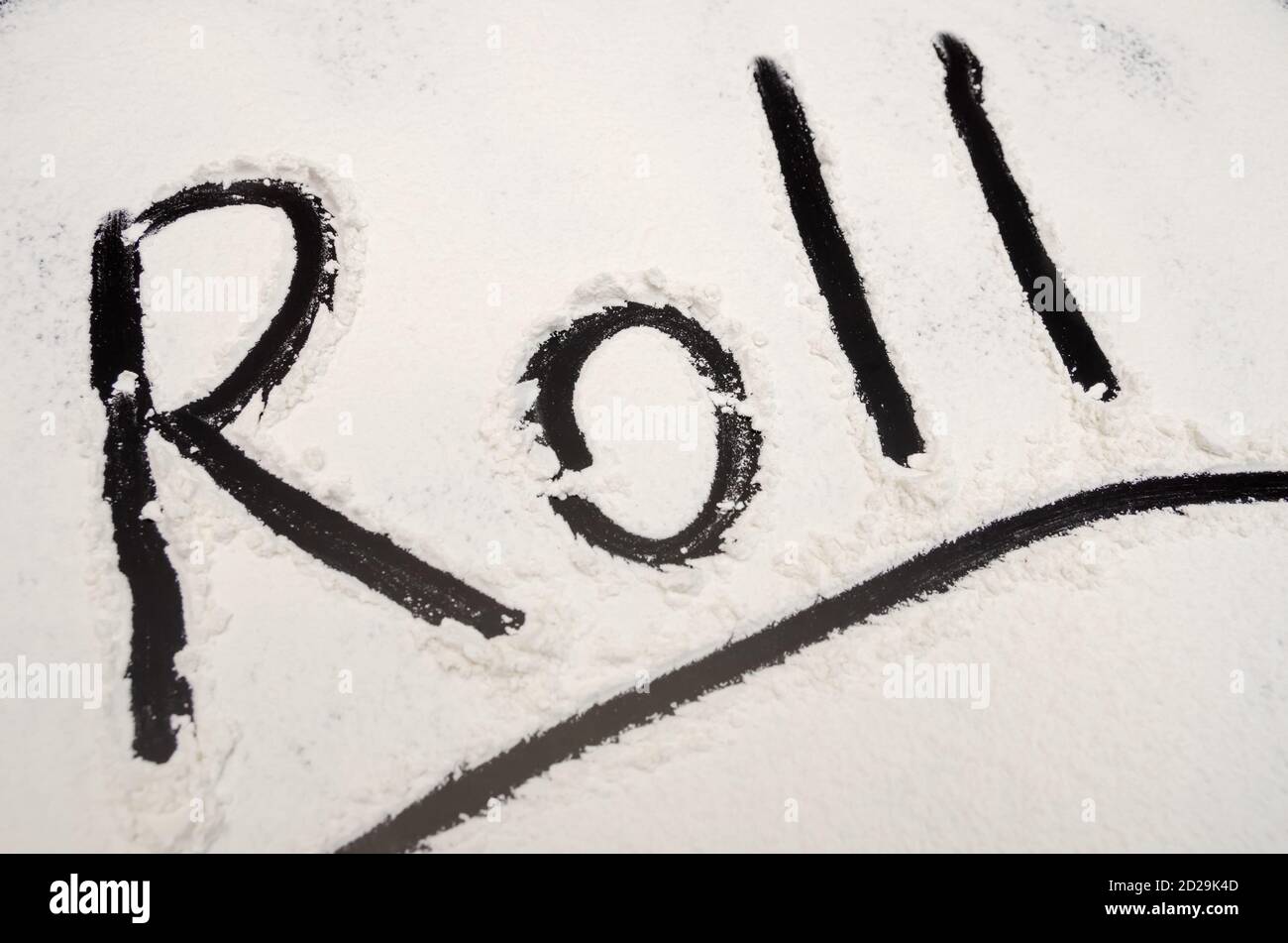 words Roll written on a black background with flour. Inscription Stock ...