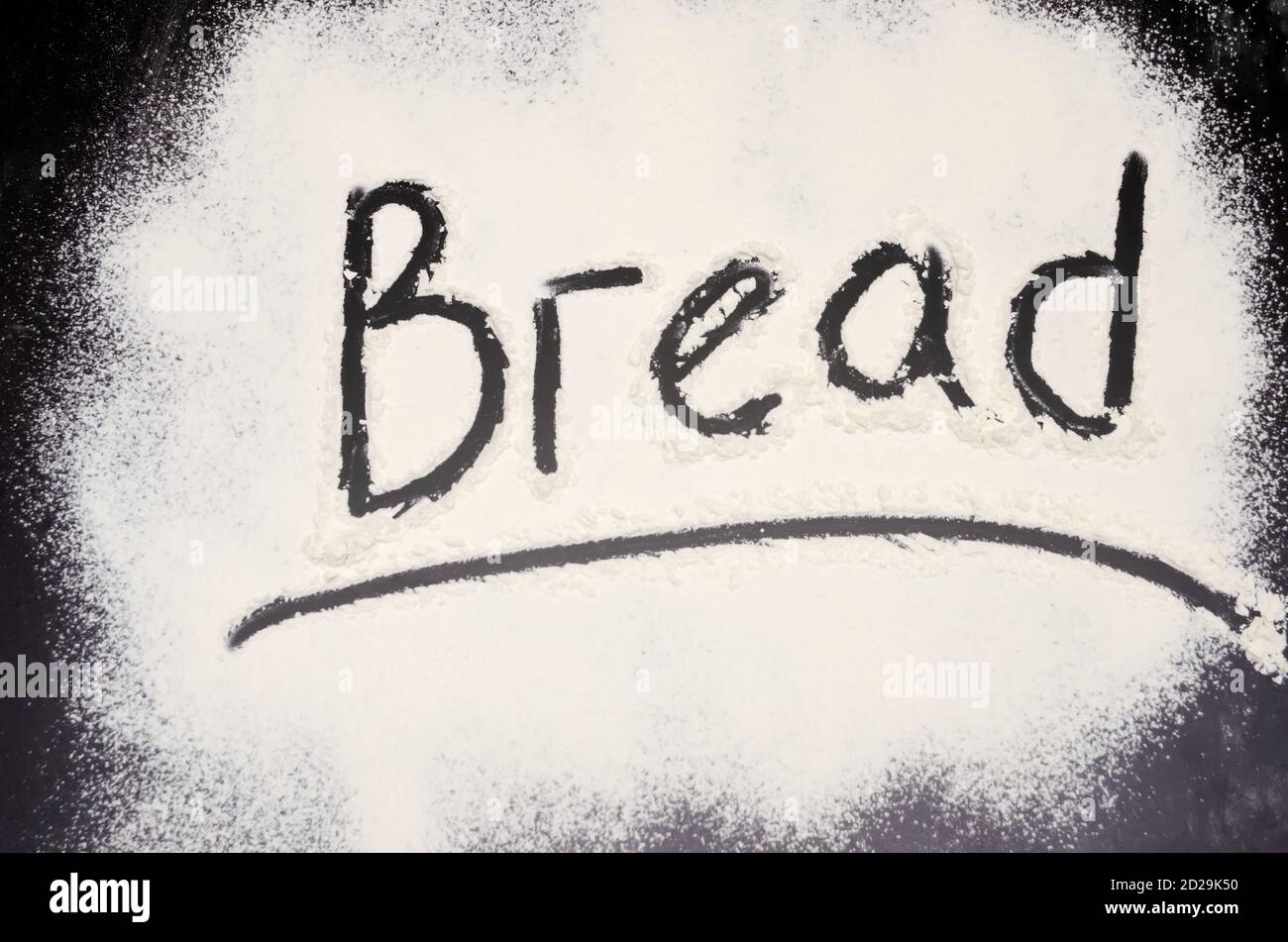 words Bread written on a black background with flour. Inscription Stock ...