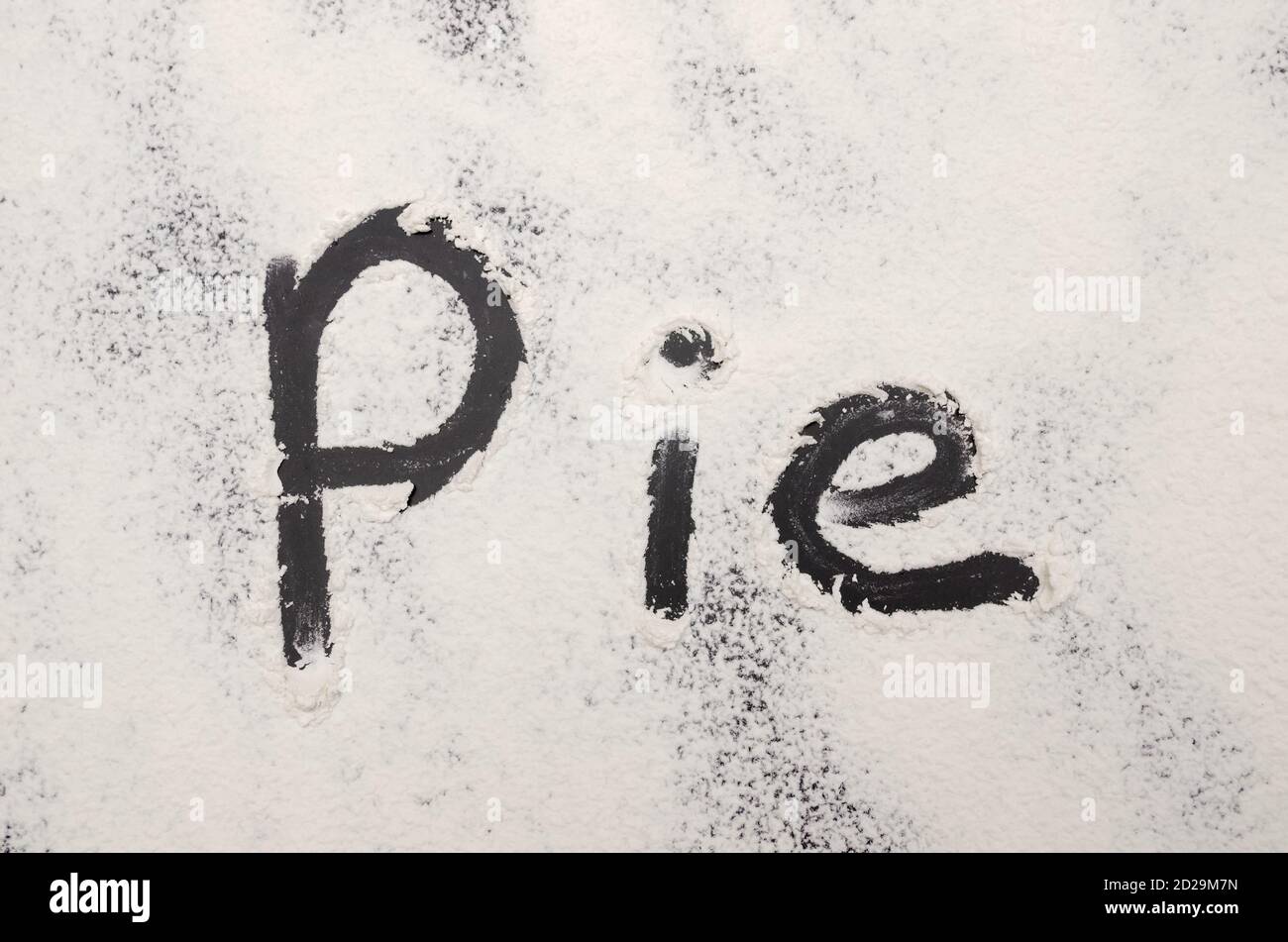 word Pie is written on a black background with the flour. Inscription ...