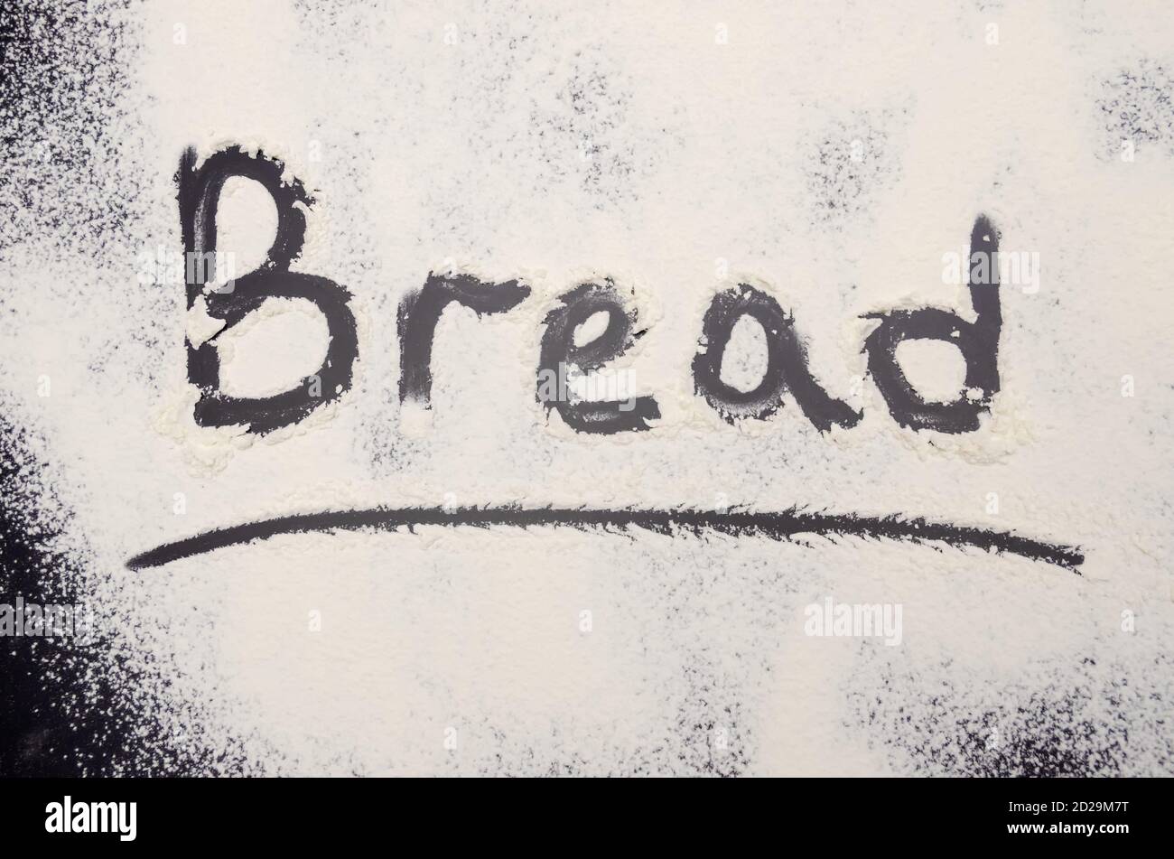 words Bread written on a black background with flour. Inscription Stock ...