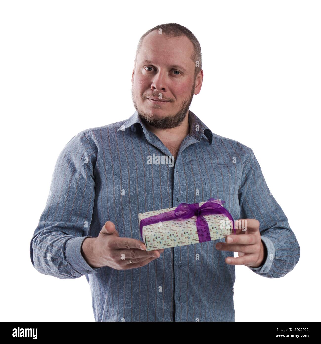emotional actor man in a gray shirt with two gift boxes in his hands ...