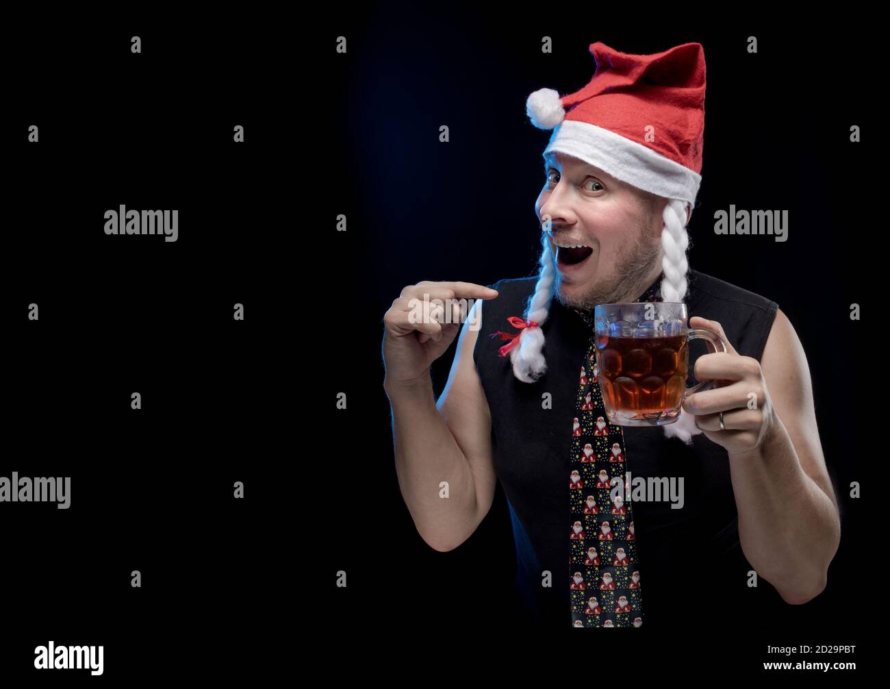 Comic actor man in cap with braids with a glass of beer on a black ...