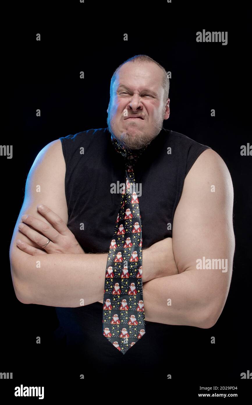 Emotional comic actor gesturing man in a tie on a black background ...