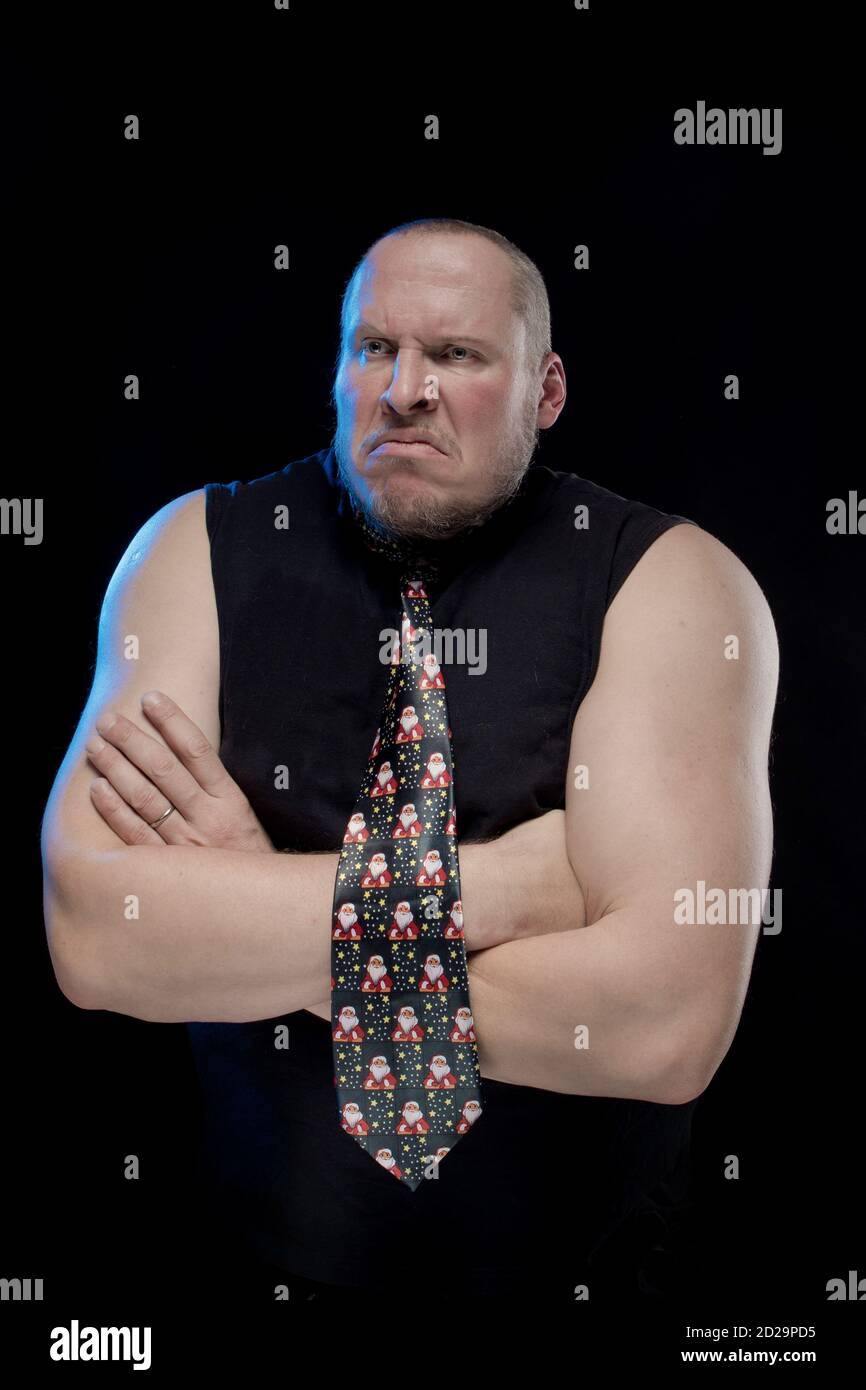 Emotional comic actor gesturing man in a tie on a black background ...