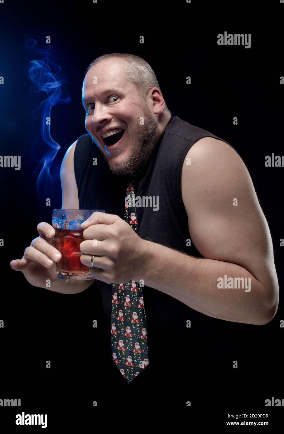 Comic actor man in cap with braids with a glass of beer on a black ...
