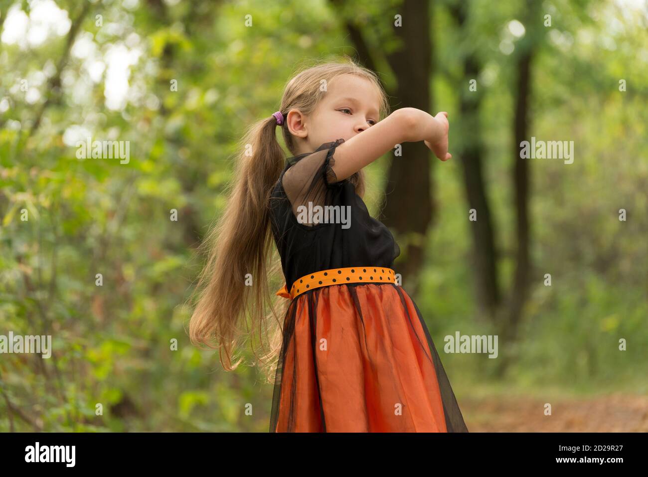 Happy little girl wearing a witch carnival costume and basket for ...