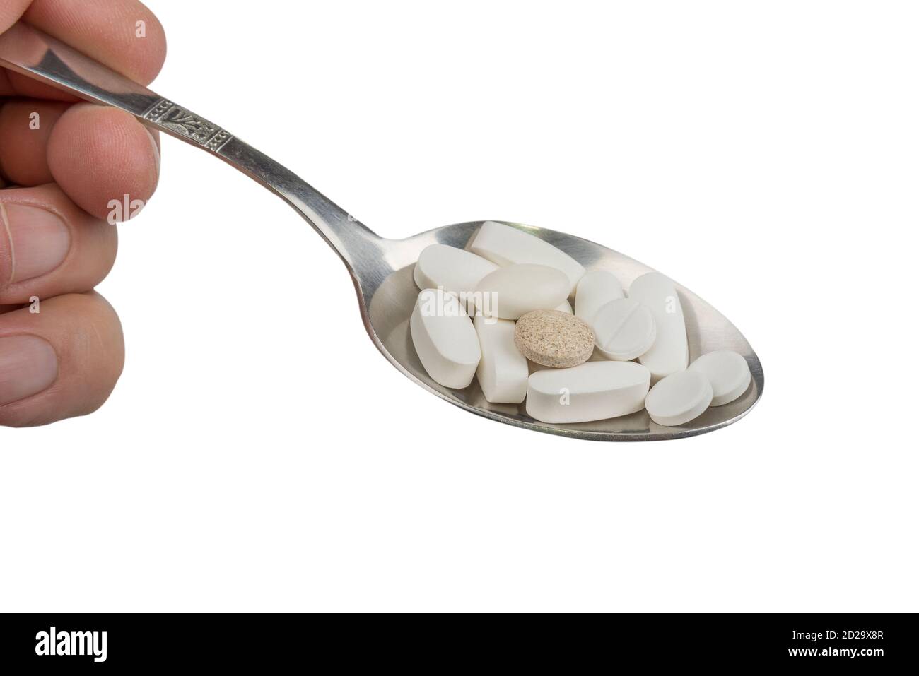 Spoon full of pills on a white background Stock Photo - Alamy
