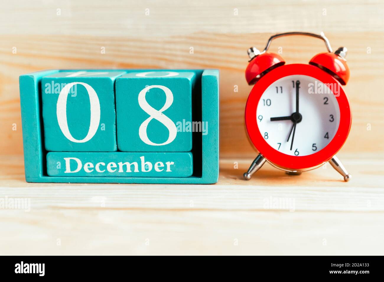 December 8. Blue cube calendar with month and date on wooden background ...