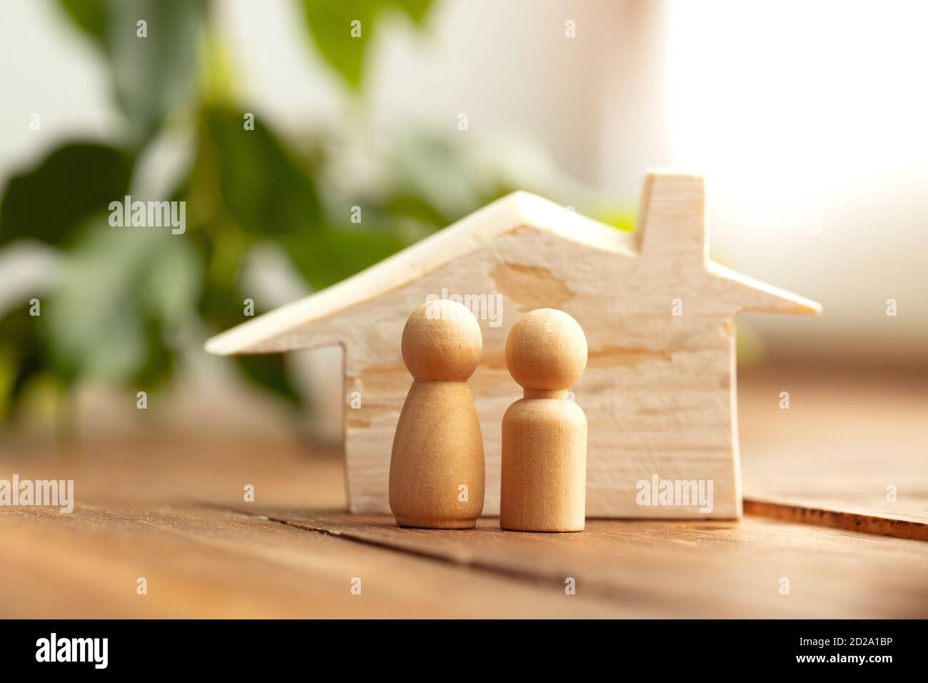 Wooden men figures and toy wooden house Stock Photo - Alamy