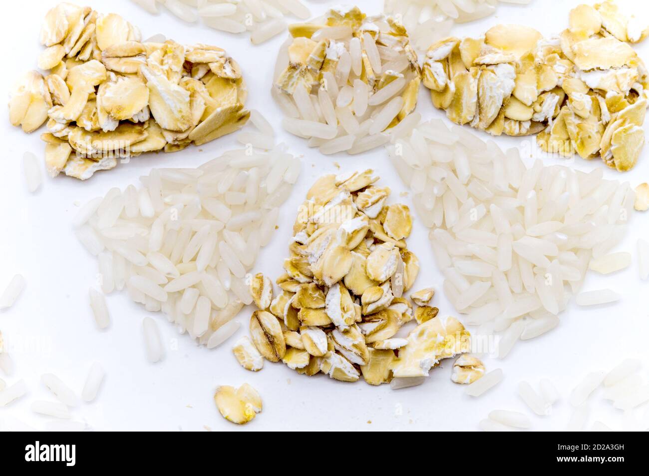snowflake of rice and oatmeal, oatmeal and rice on a white background ...