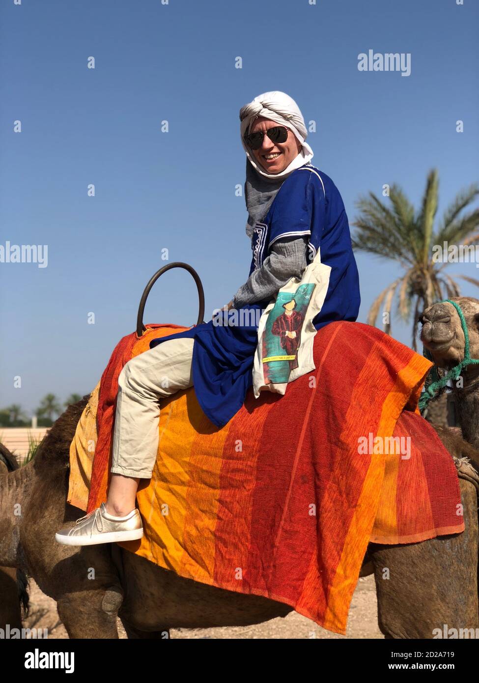 Tourist woman rides a camel during the tourist camel tour Stock Photo ...