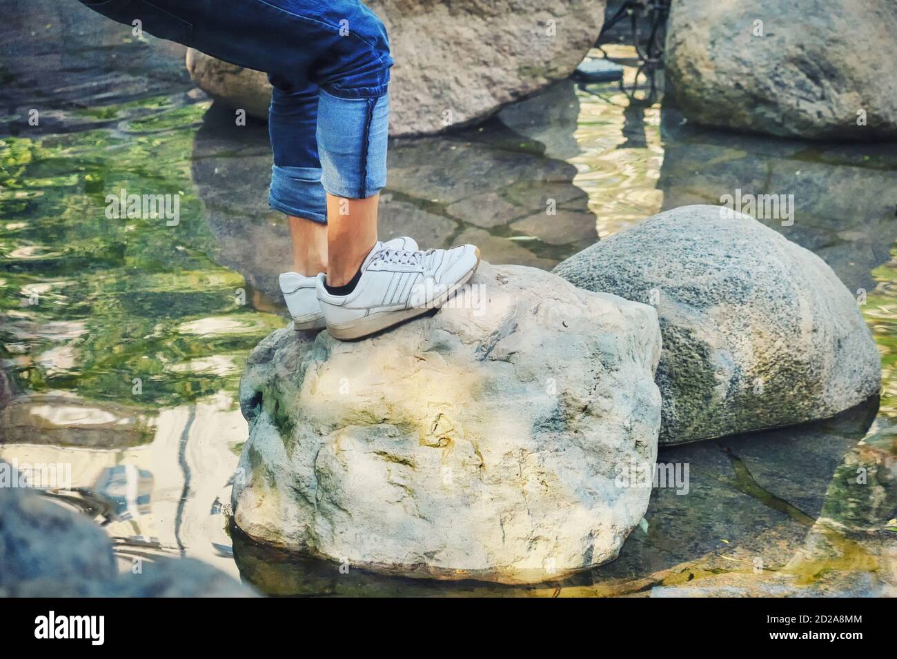 Man can not keep his balance and falls into the water. Feet on the ...